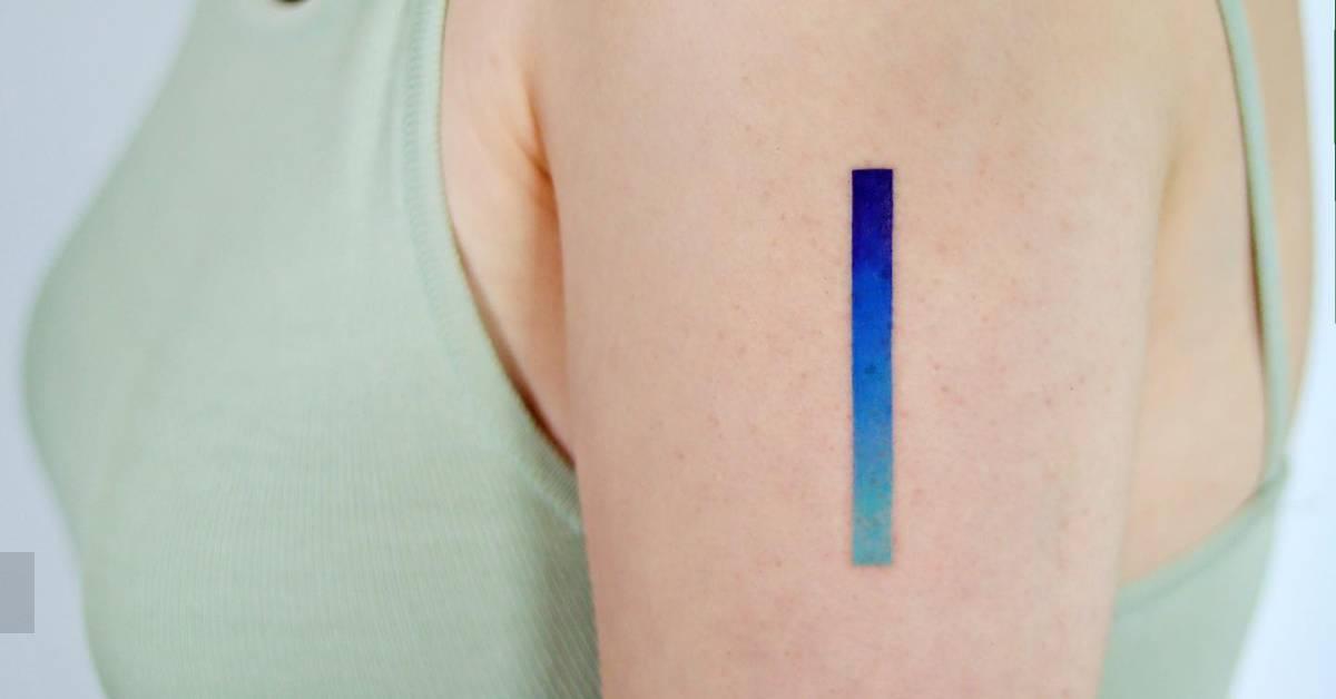 Blue spectrum tattoo located on the upper arm.