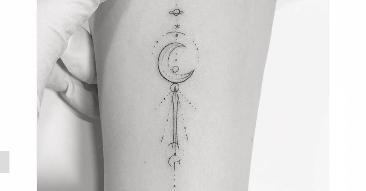 Fine line style ornamental moon tattoo located on the