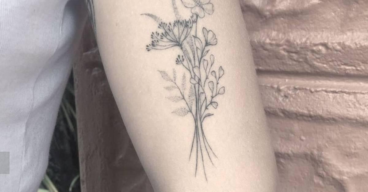Fine line flower bouquet tattoo located on the upper