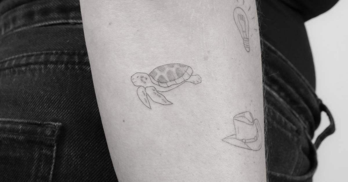 Cute little turtle tattoo located on the forearm,.
