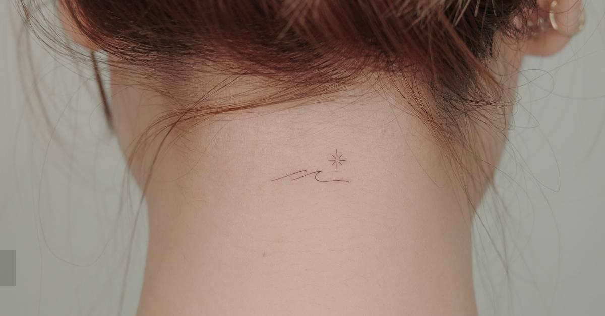 Tiny minimalistic wave and star tattoo located on the