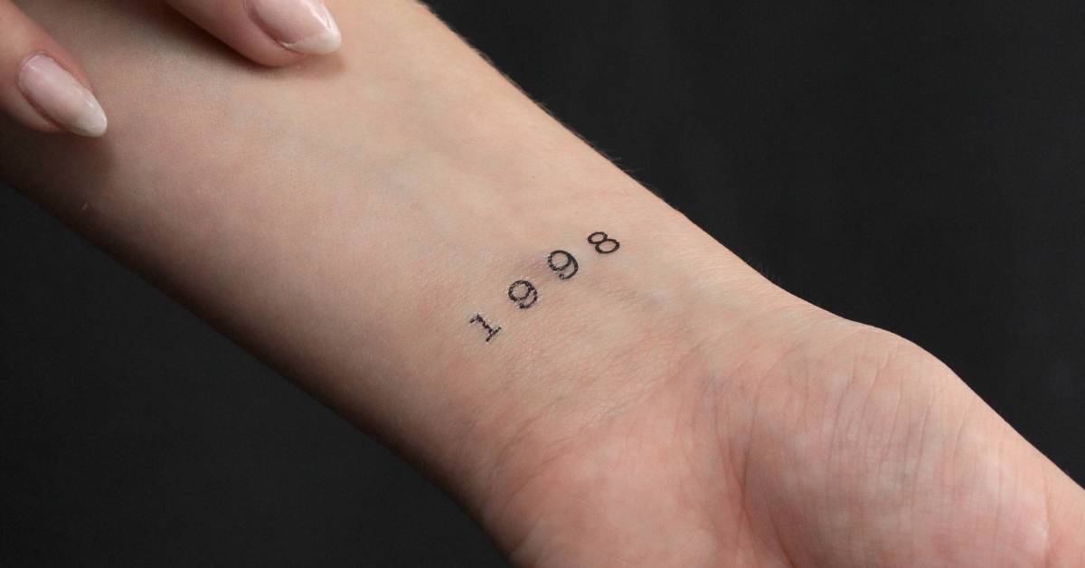 "1998" birth year temporary tattoo done on the wrist.