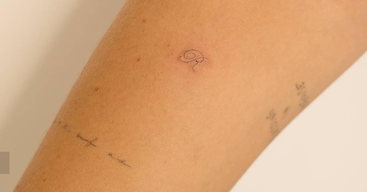 Little tattoo of the letter "R" placed on the inner