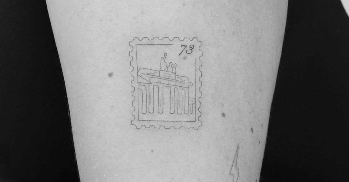 Berlin stamp tattoo in fine line style located on the