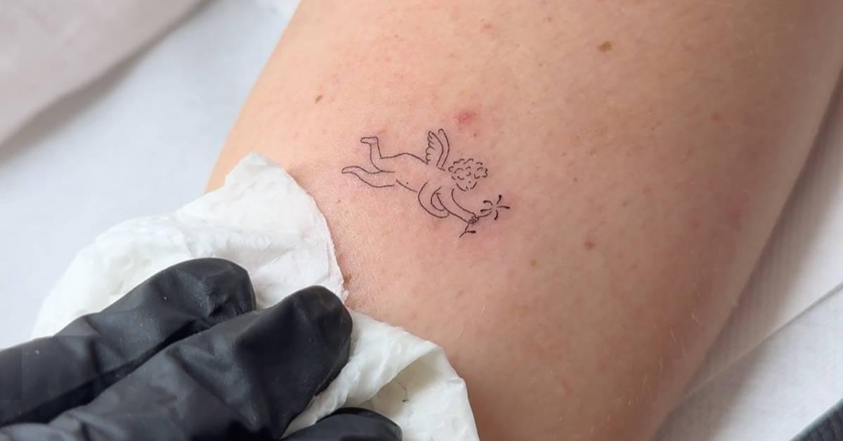 Fine line style minimalistic cherub tattoo done on the
