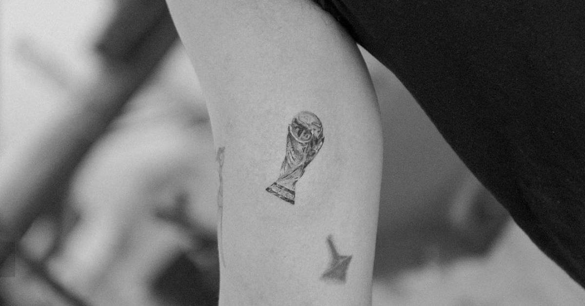 Micro-realistic style World Cup trophy tattooed on the