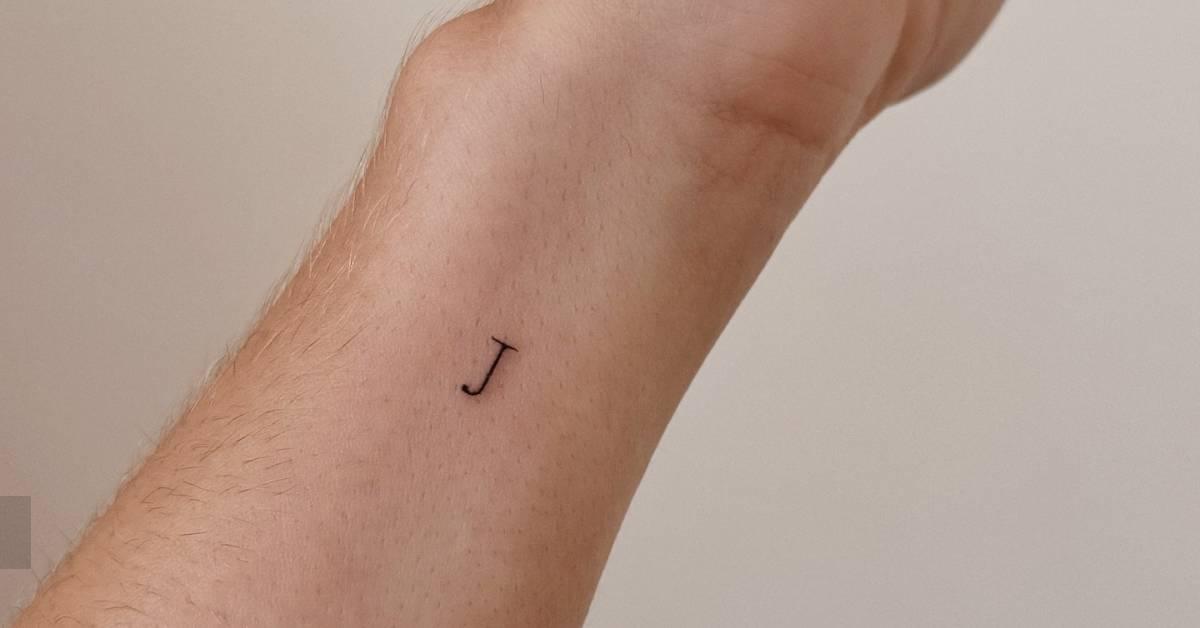 Small letter "J" tattoo placed on the wrist.