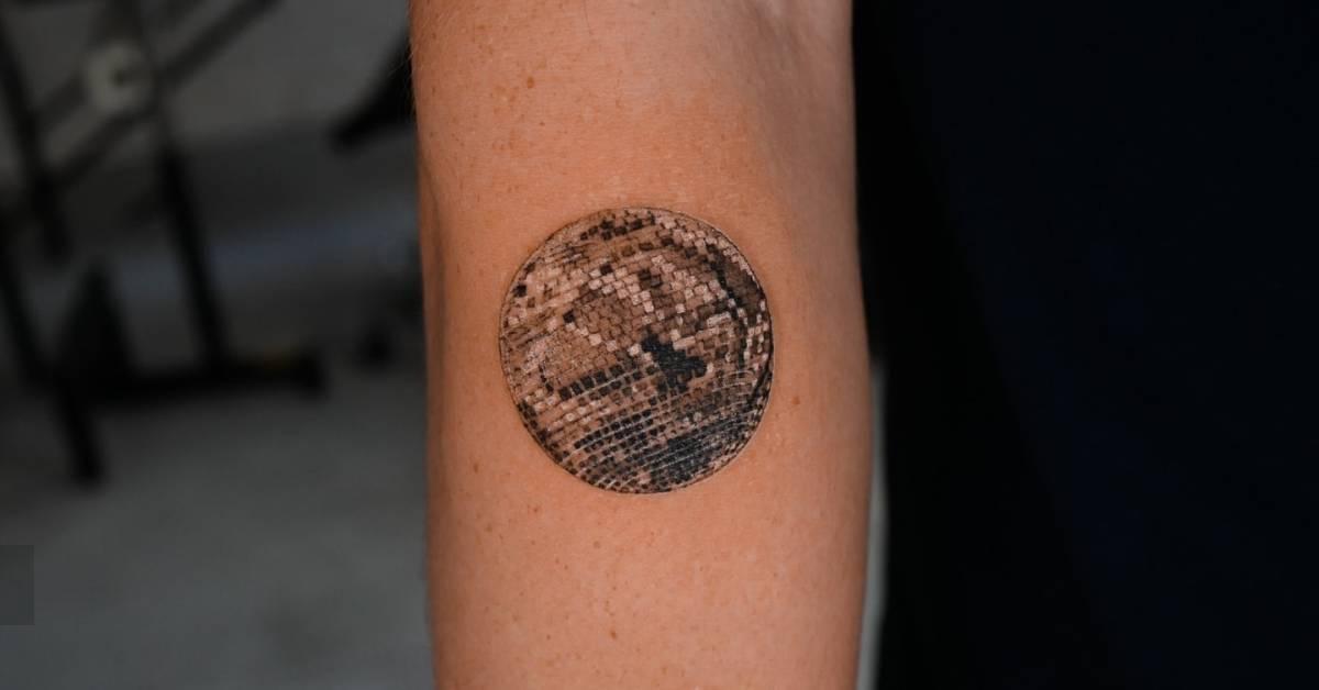 Micro-realistic style disco ball tattoo located on the