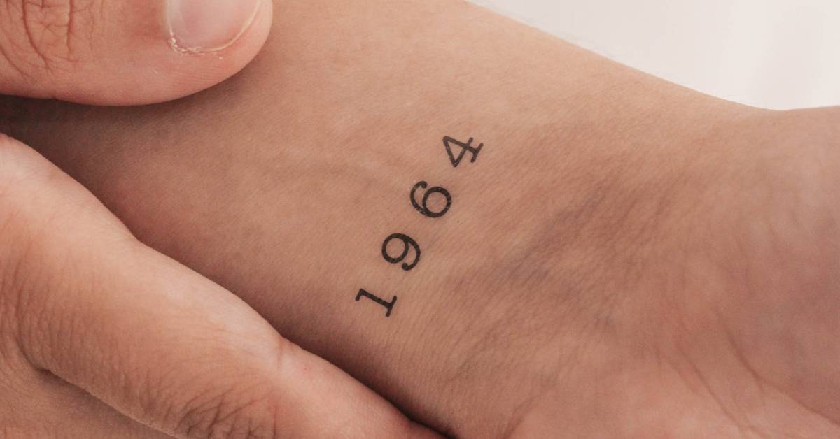 "1964" birth year temporary tattoo located on the