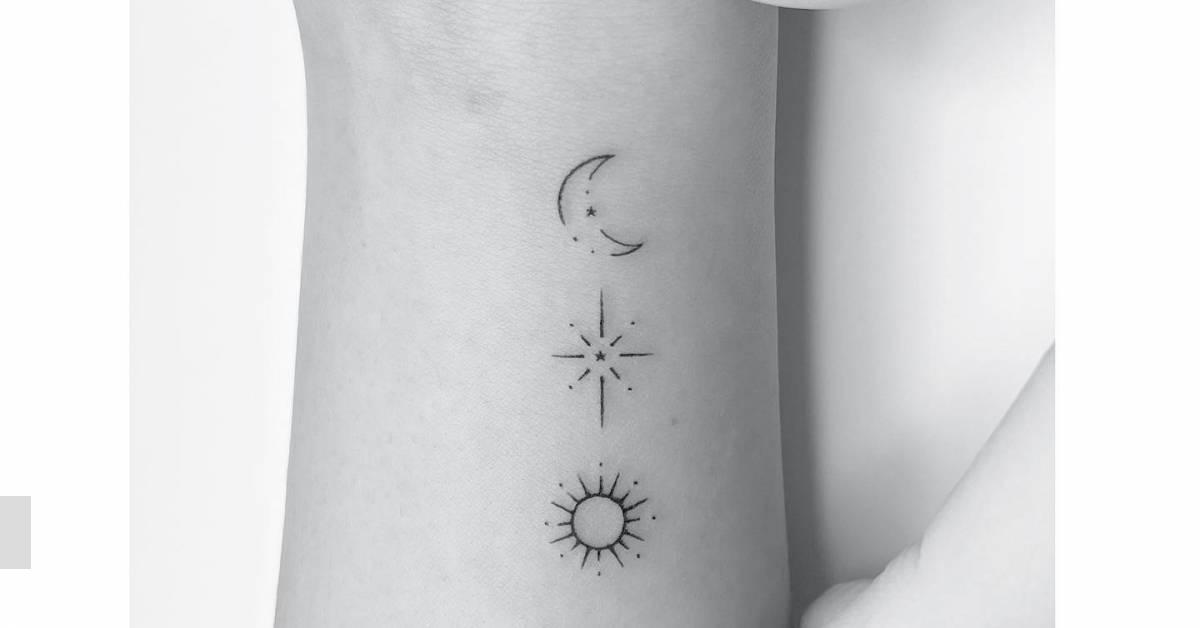 Moon, star and sun tattoo located on the wrist.