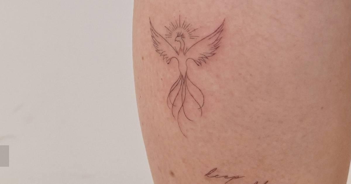 Phoenix and word "keep walking" tattooed on the calf.