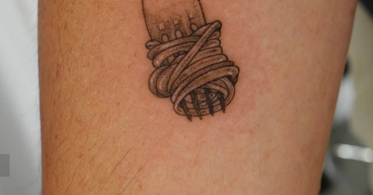 Spaghetti and fork tattoo located on the inner forearm.