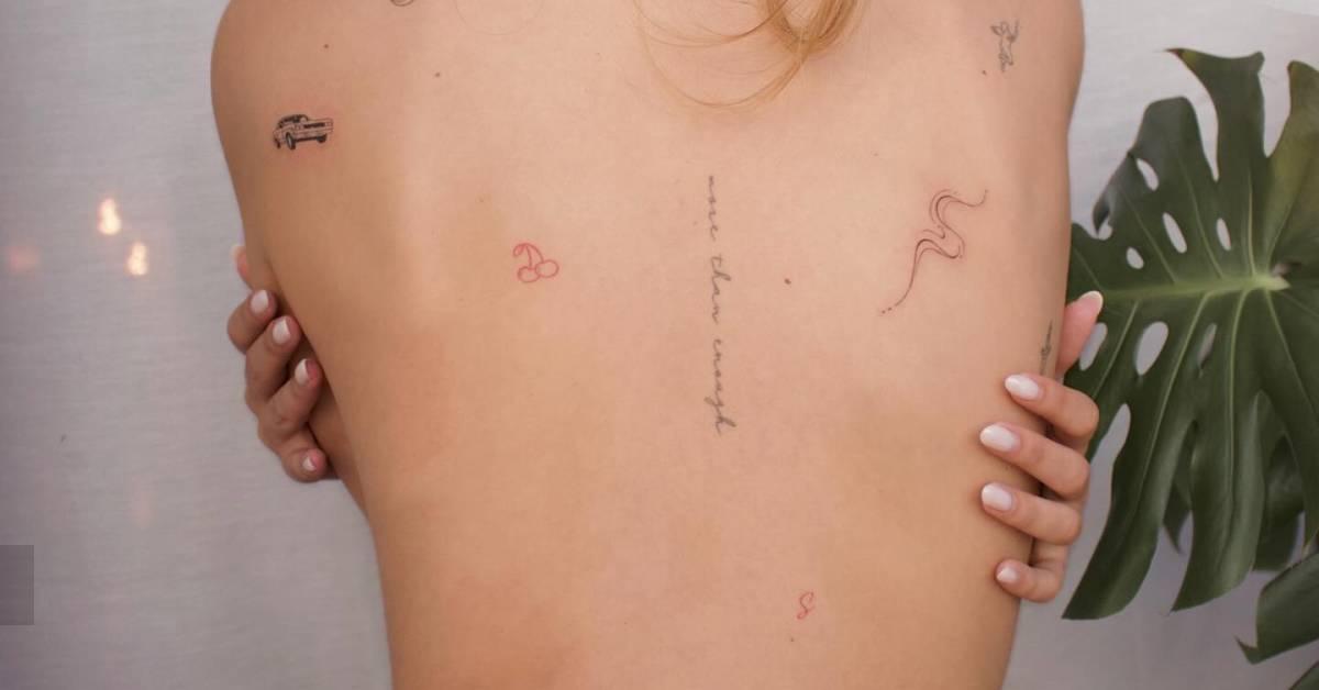 Fine line style back composition tattoos.