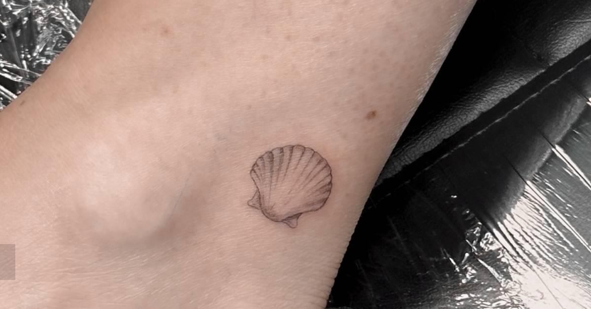 Little scallop shell tattoo located on the ankle.