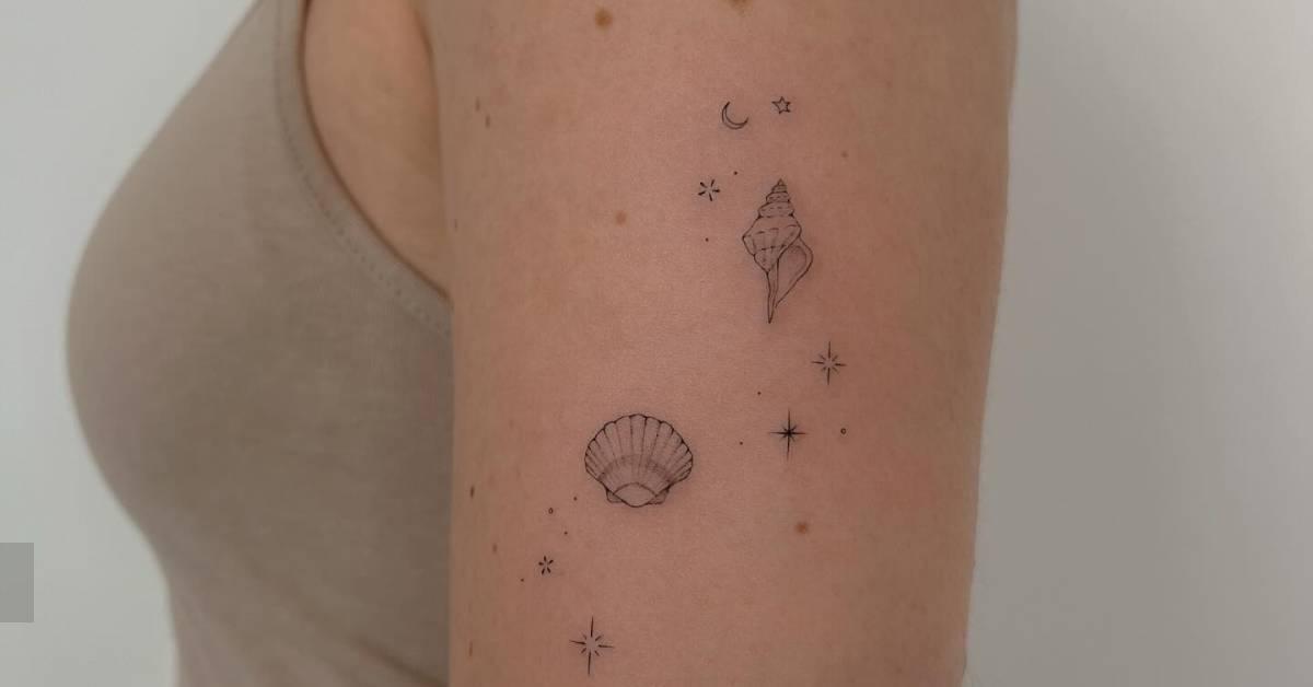 Shells and stars tattoo in fine line style located on