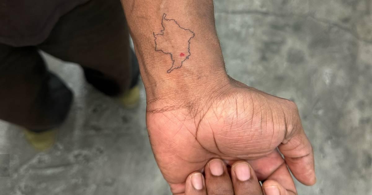 Minimalistic style Colombia map tattoo located on the