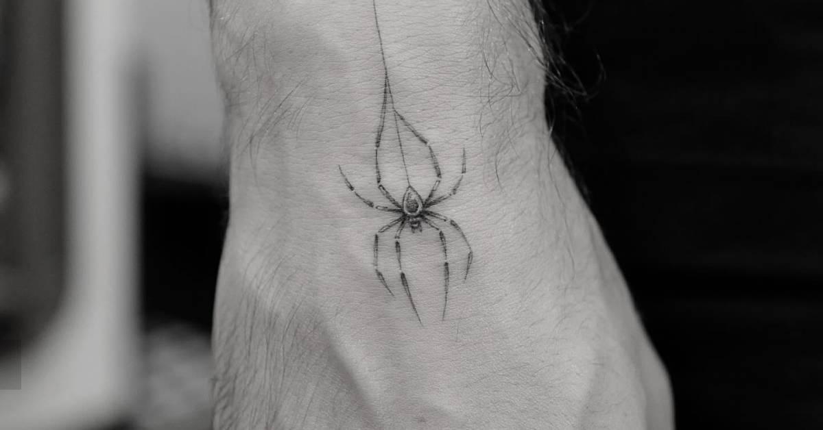 Single needle spider tattoo located on the wrist.