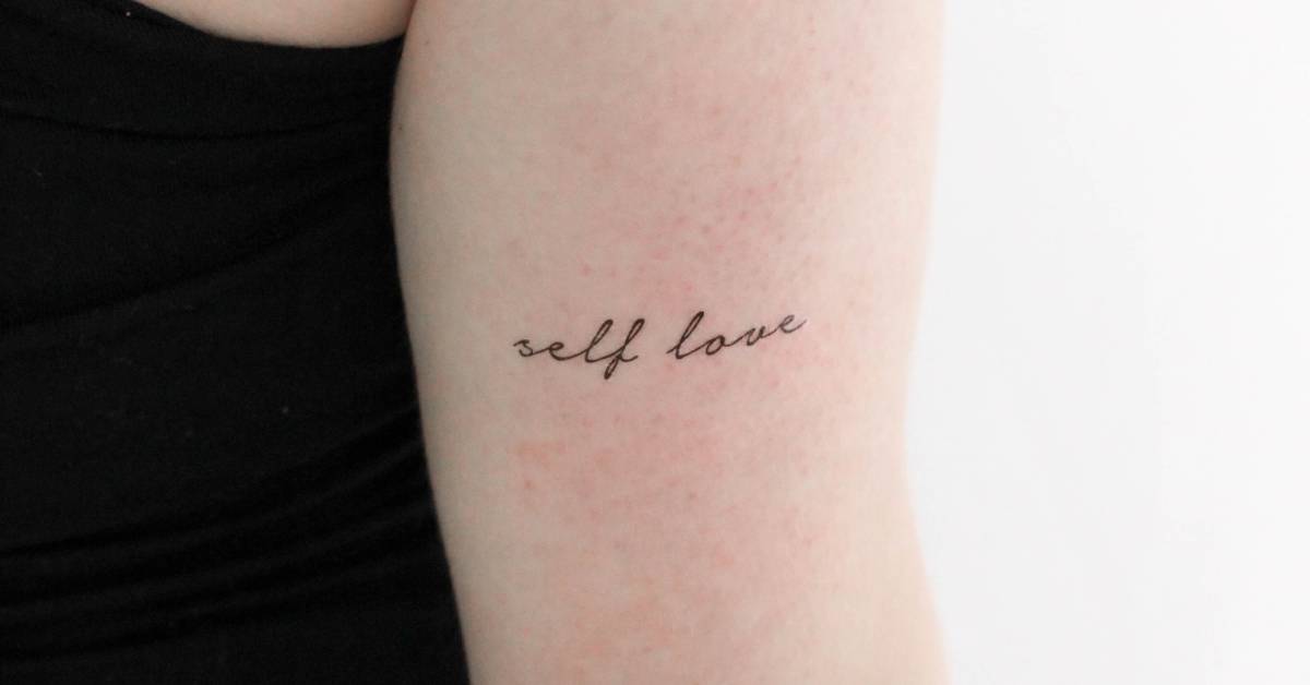 Handwritten "self love" temporary lettering tattoo.