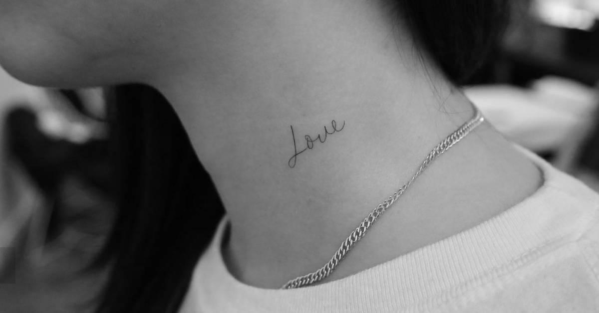 Tattoo of the word "love" handwritten on the neck.