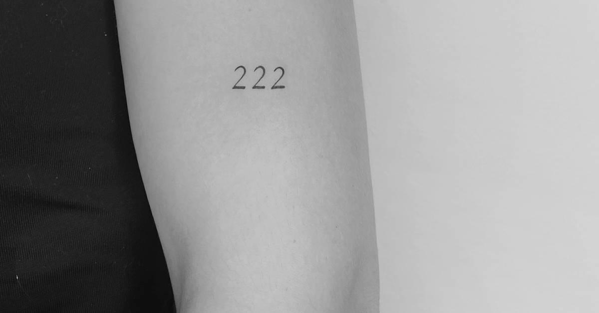 Angel number "222" tattoo located on the upper arm.