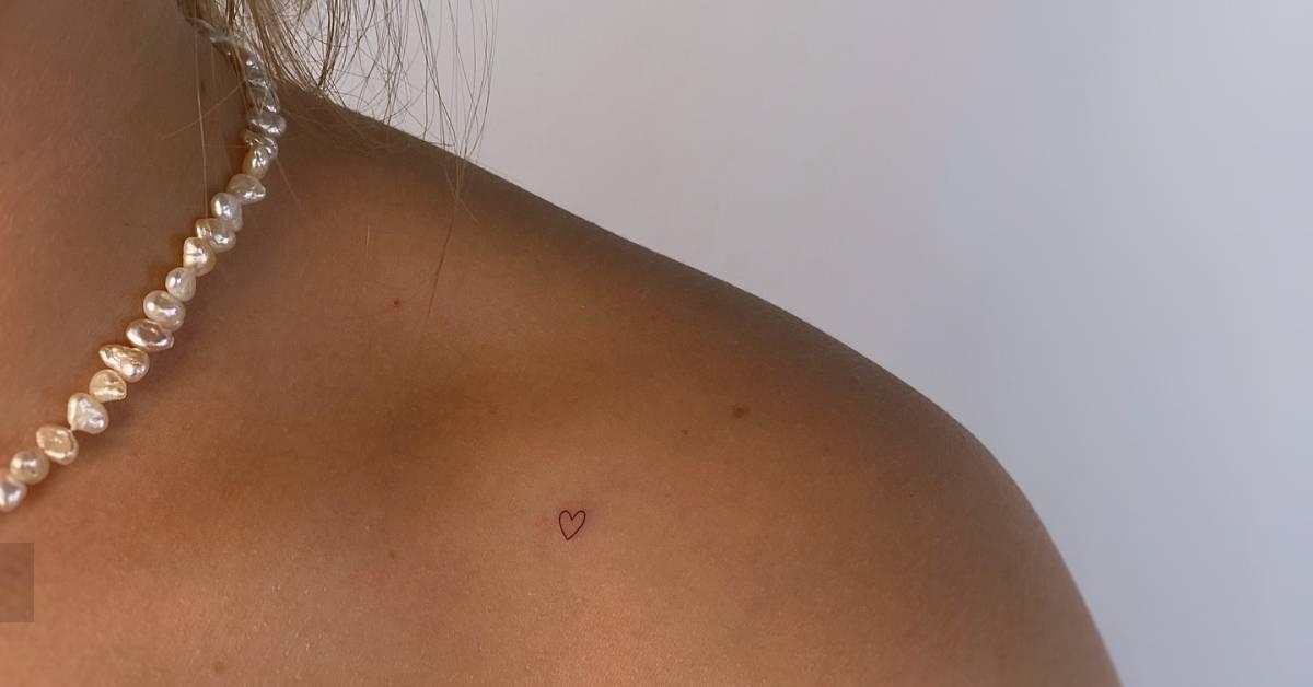 Micro heart tattoo located on the shoulder,