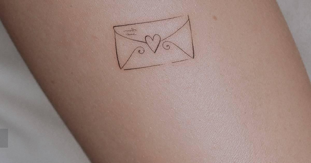 Fine line style love letter tattoo done on the upper