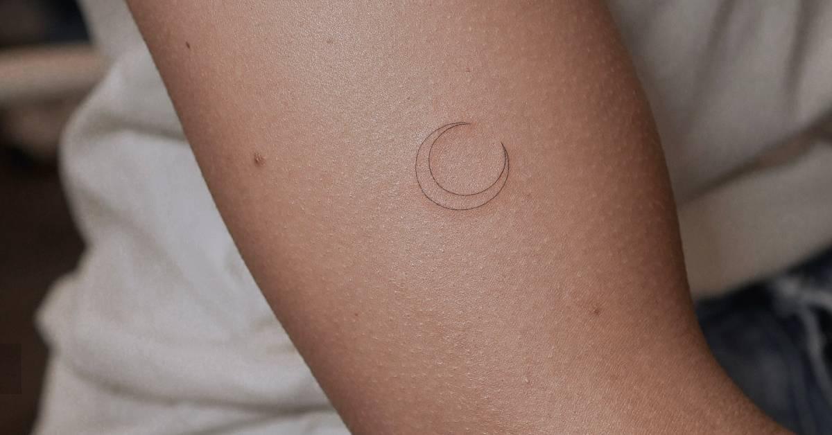Little fine line crescent moon tattoo done on the upper