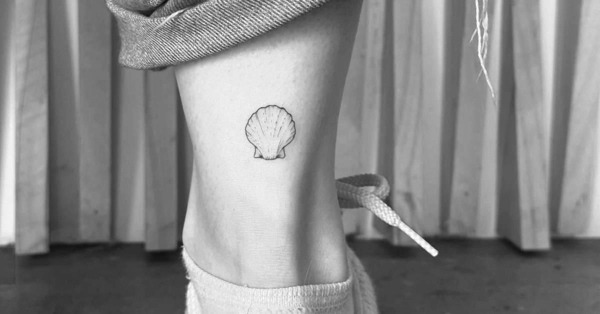 Scallop shell tattoo in fine line style located on the