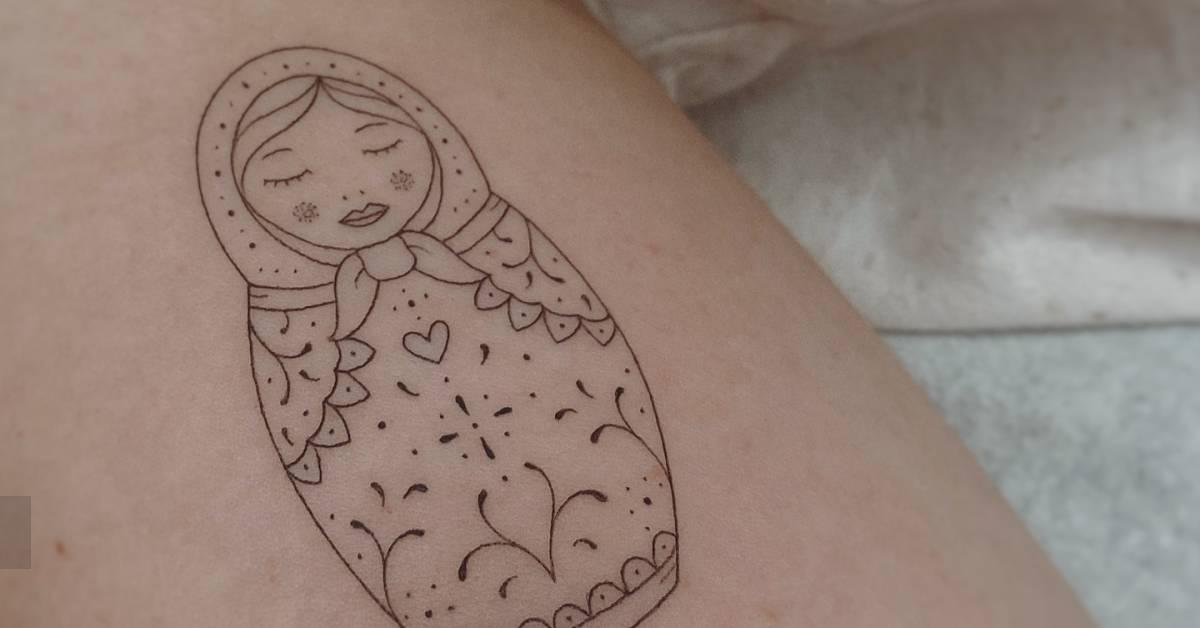 Matryoshka doll tattoo in fine line style located on