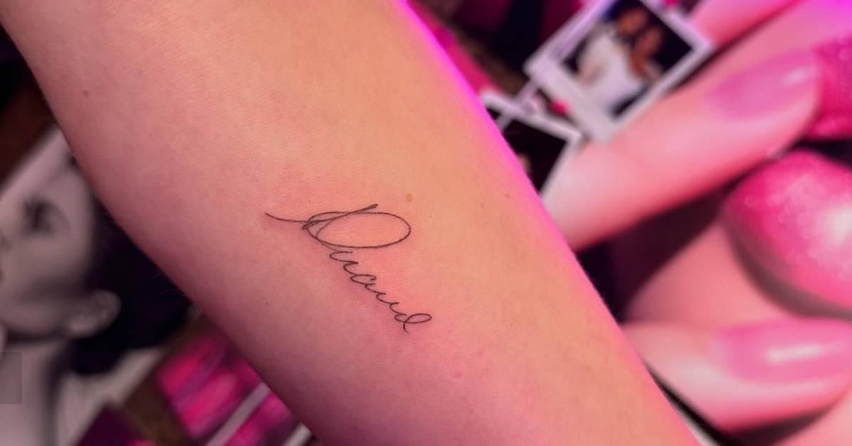 Signature tattoo located on the inner forearm.