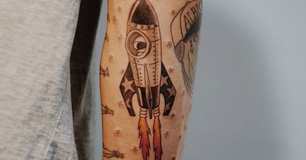 Rocket tattoo on the right forearm.