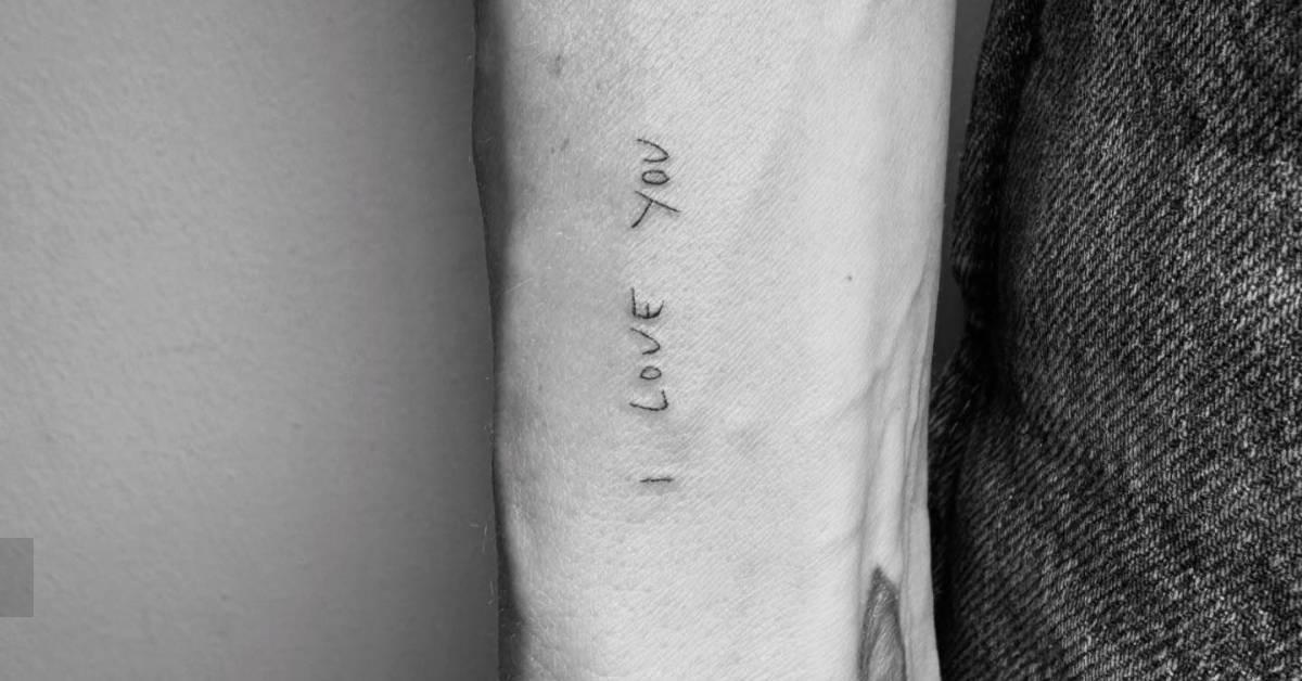 "I love you" handwritten lettering tattoo located on