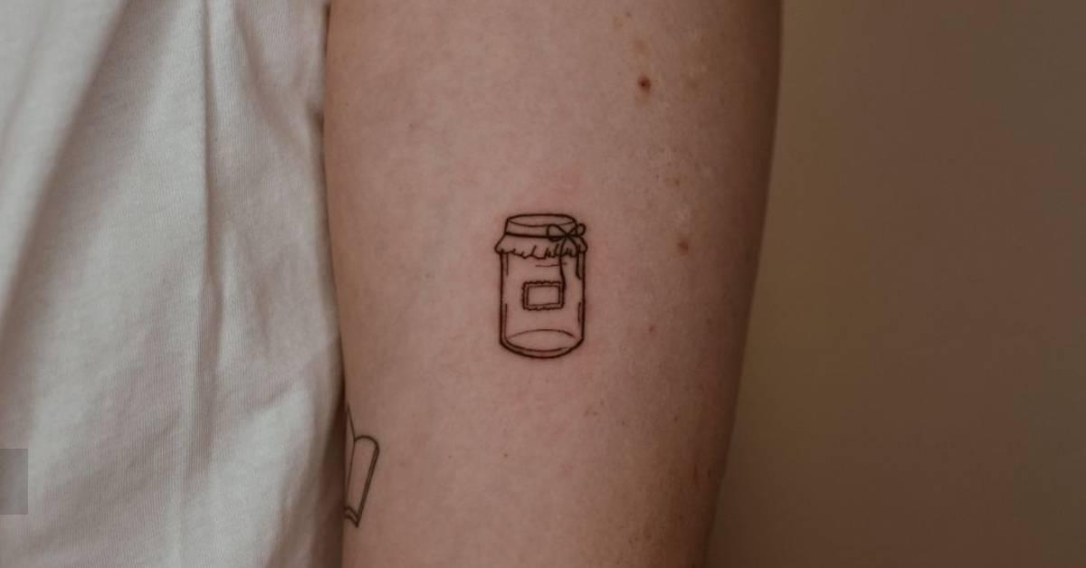 Jar tattoo located on the upper arm, fine line style.