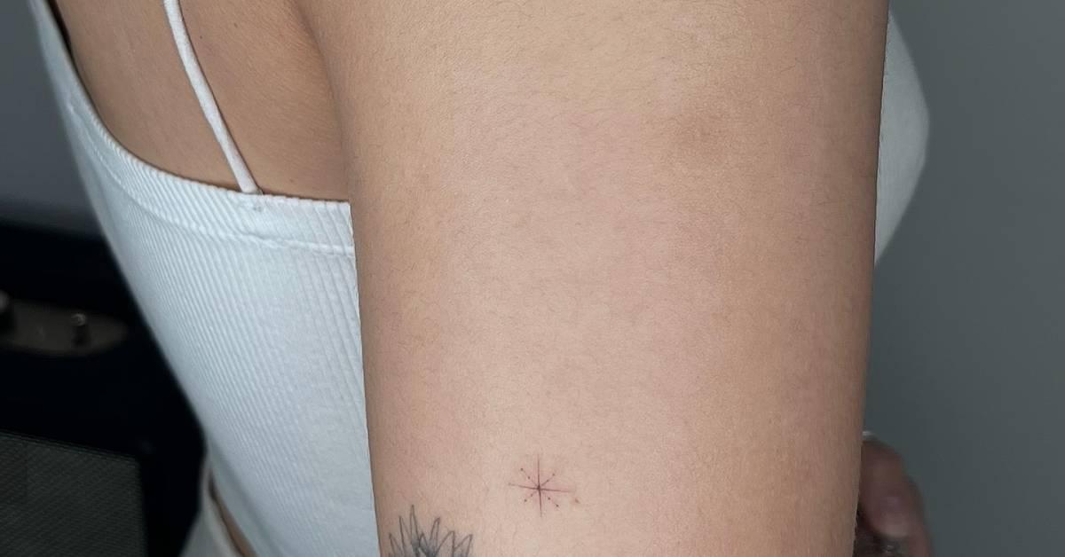 Mini star tattoo in fine line style located on the