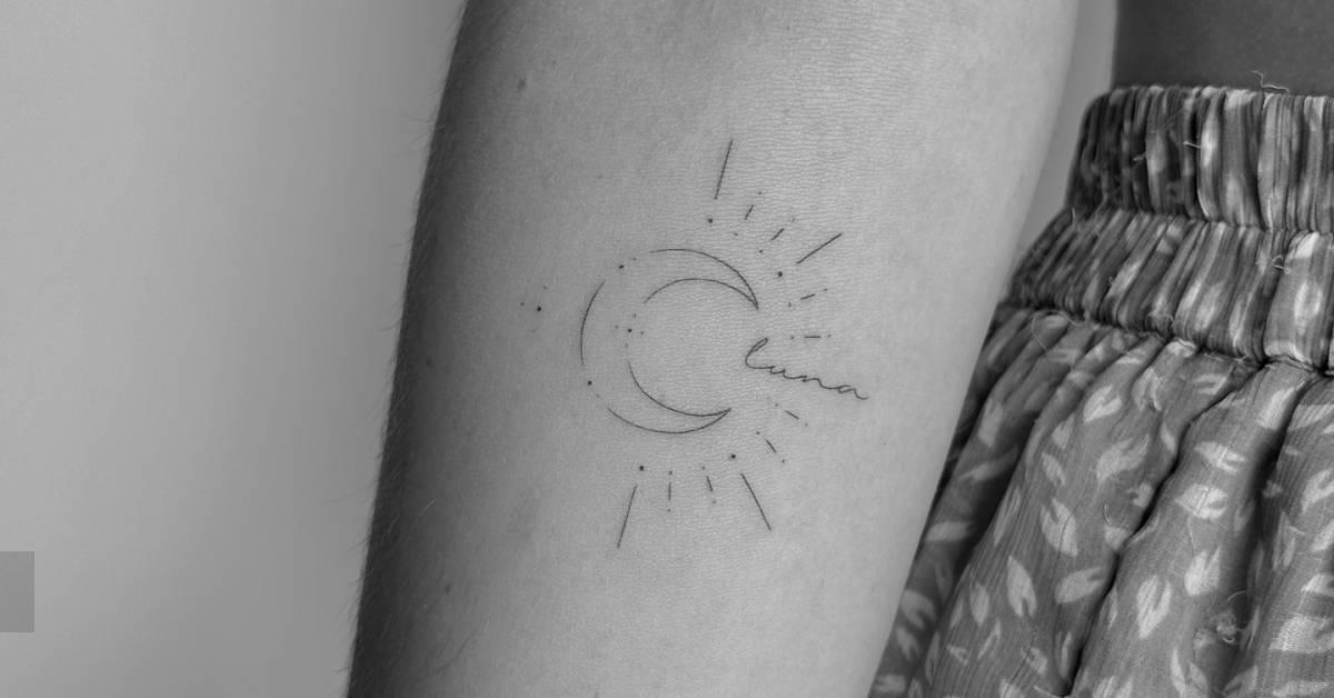 Fine line style crescent moon and word "luna" tattooed