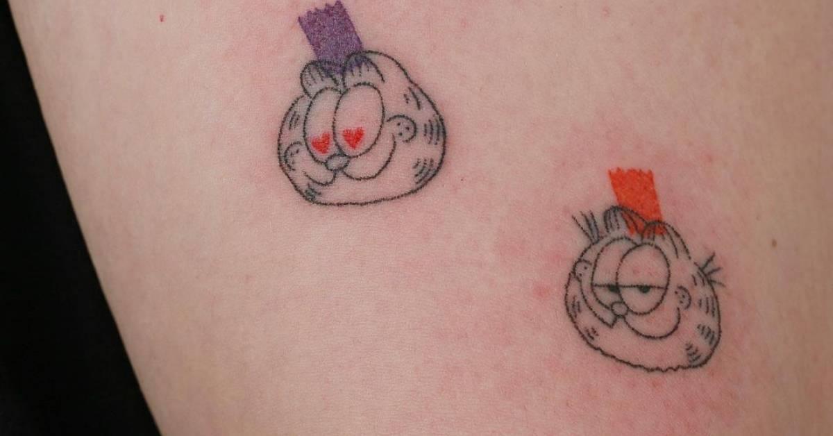 Hand poked Garfield tattoo on the upper arm.