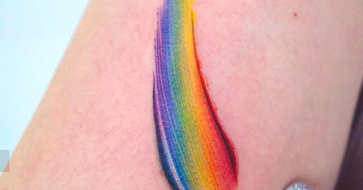 Visible spectrum brush stroke tattoo located on the