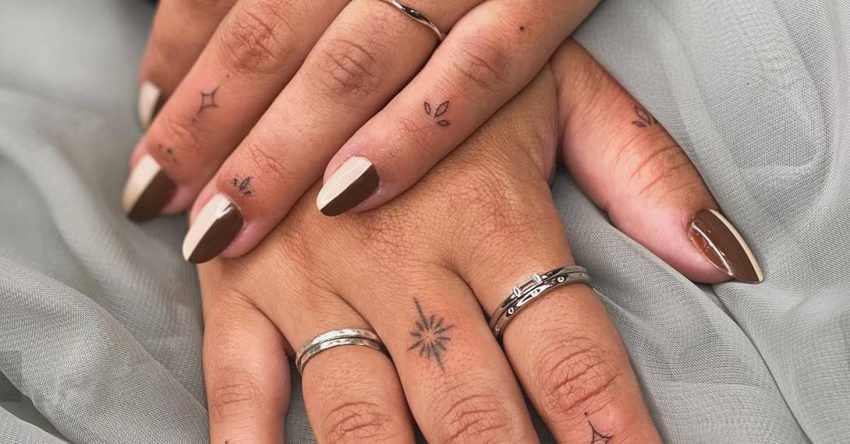 Fine line style finger composition tattoos.