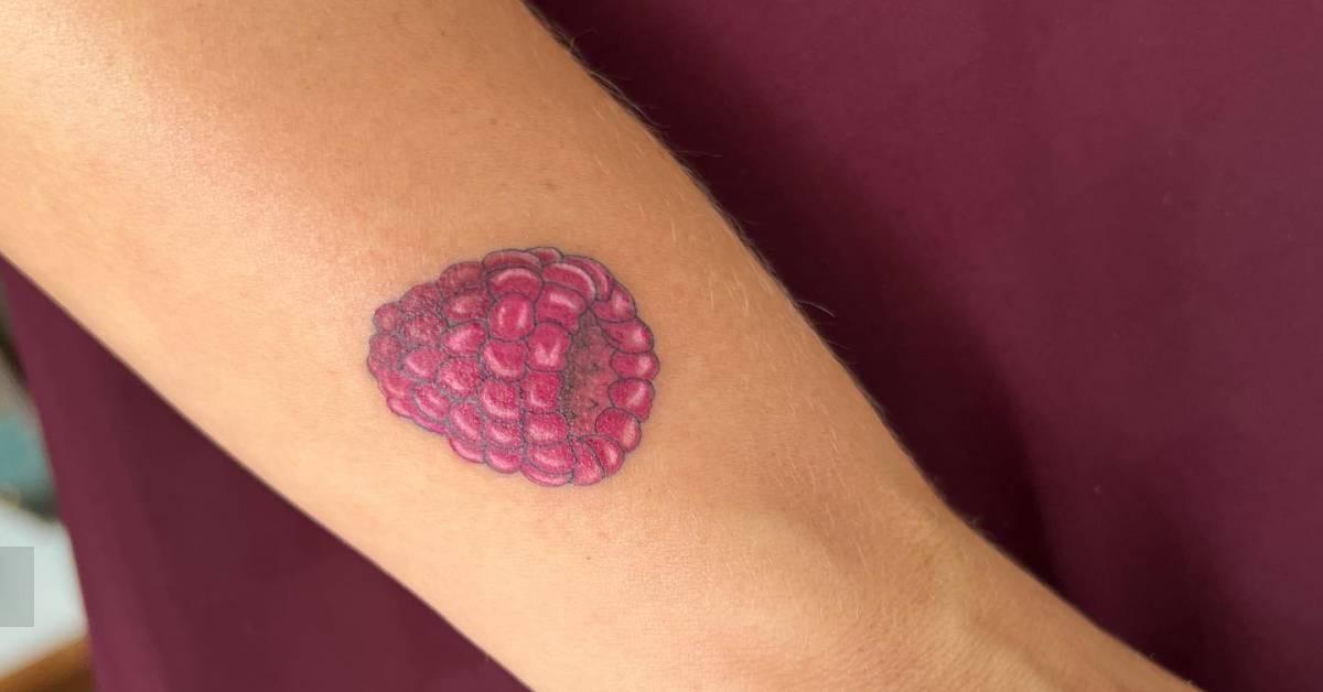 Raspberry tattoo located on the wrist, done in
