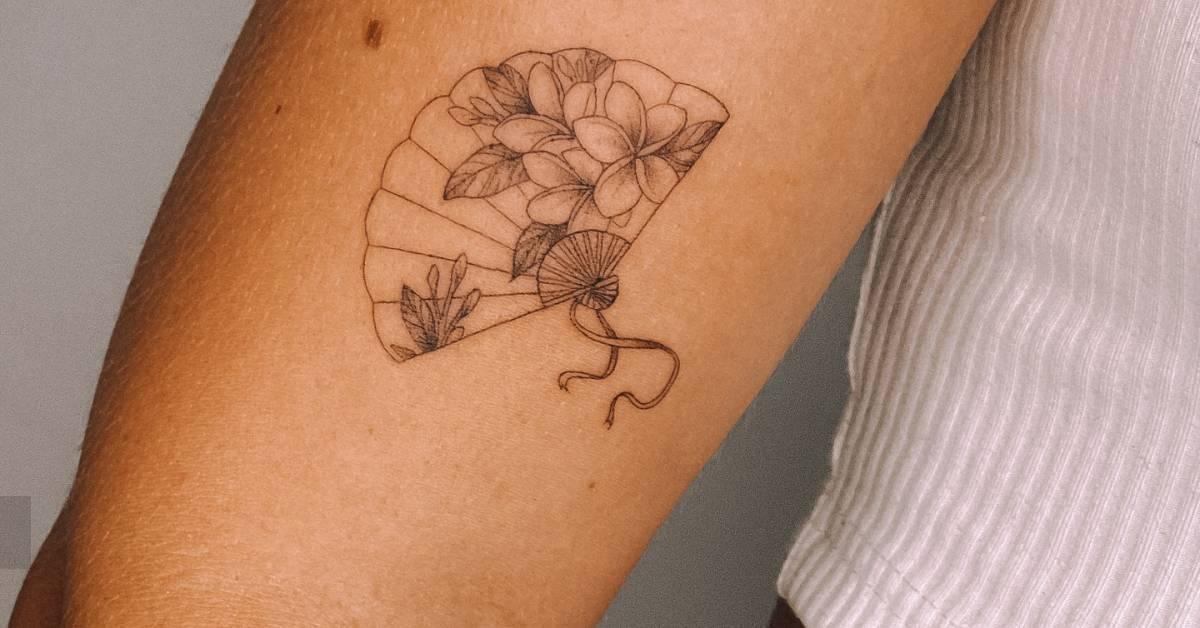 Fine line style hand fan tattoo located on the upper