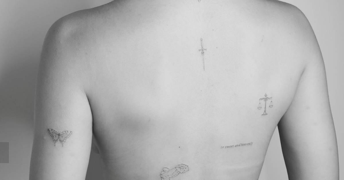 Fine line style back composition tattoos.