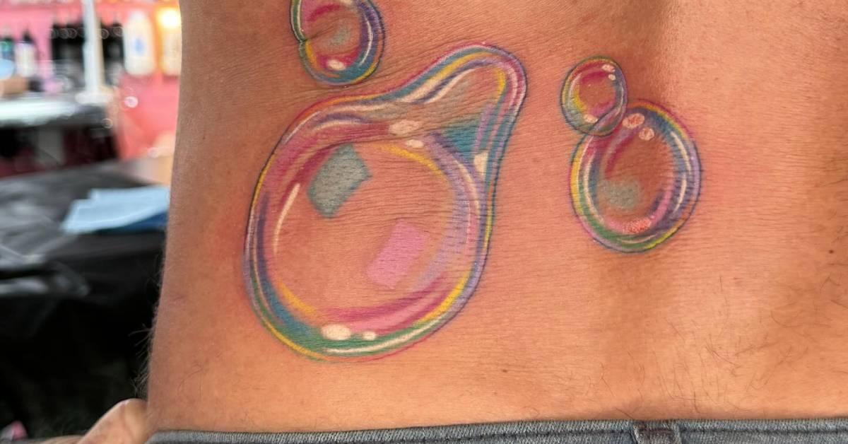 Soap bubbles tattoo located on the lower back,