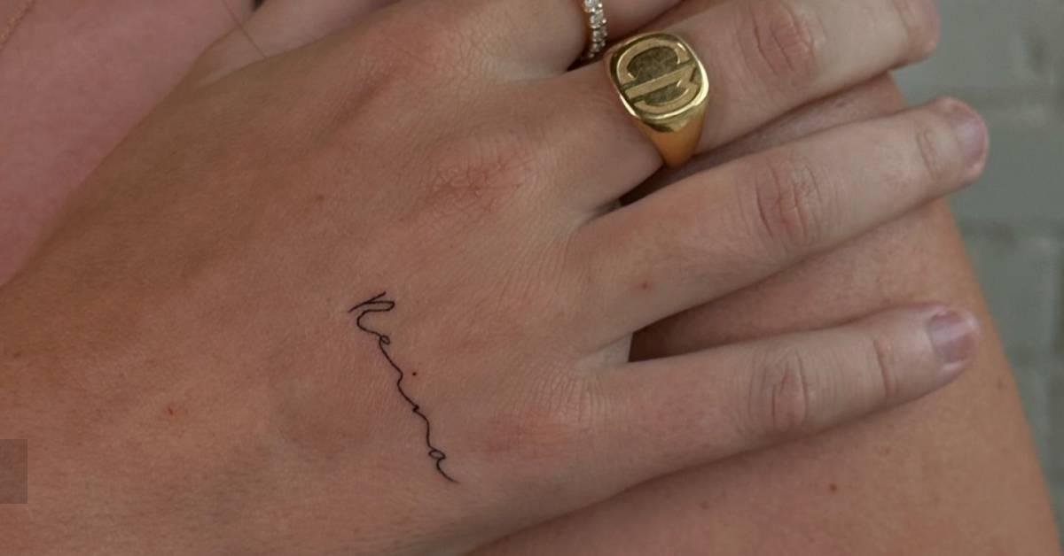 Lettering tattoo of the word "reina" located on the