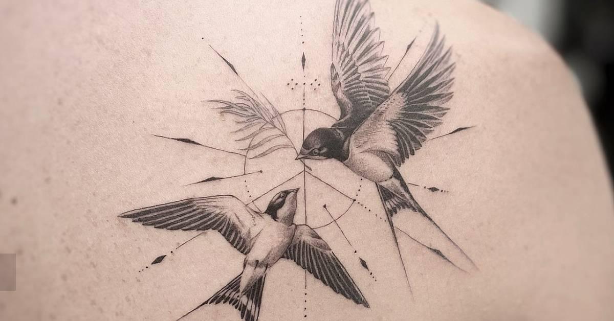 Swallows tattooed on the shoulder blade, done in