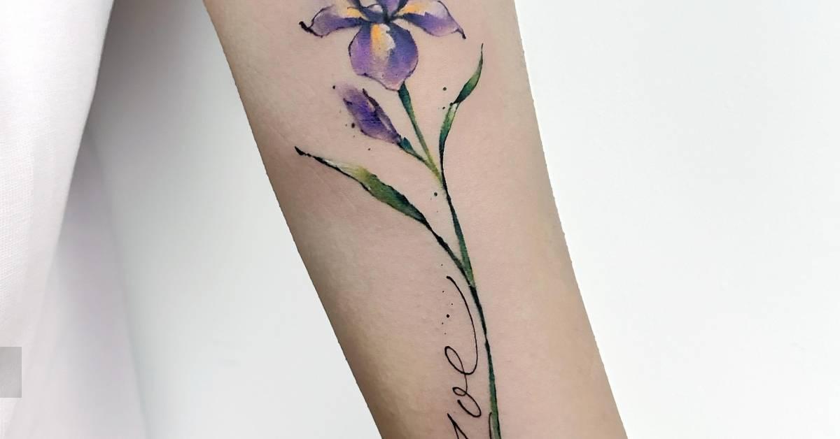 Iris flower and name "Zoe" tattooed on the inner