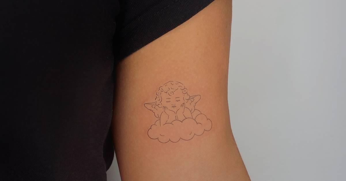 Cherub tattoo in fine line style located on the inner