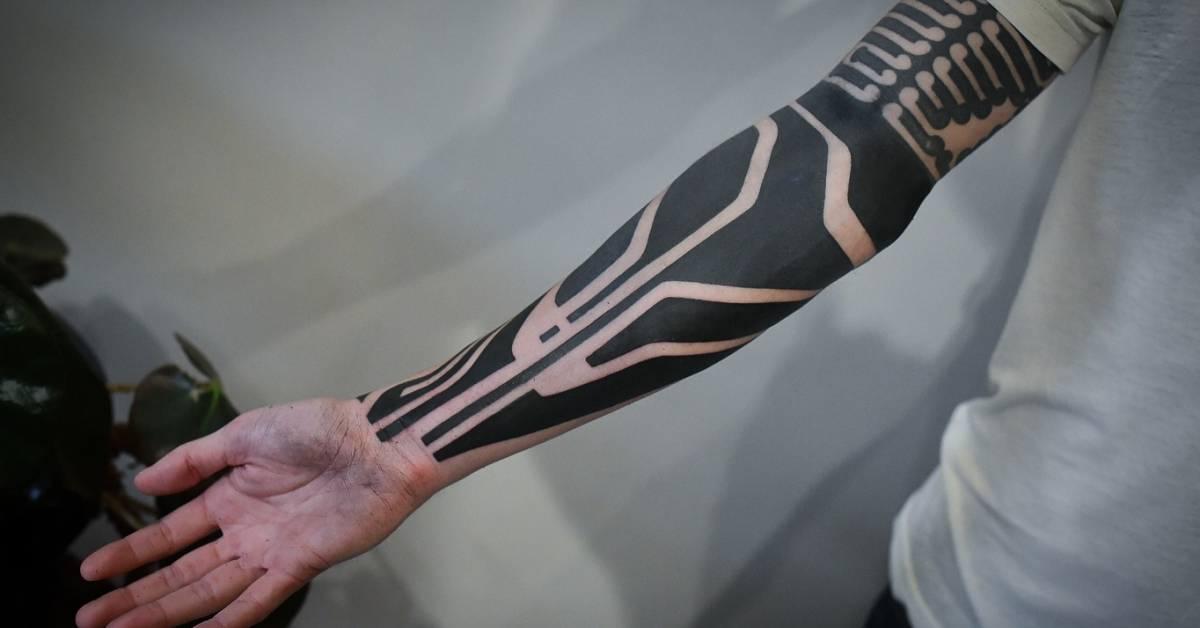 Cybernetic tattoo sleeve in blackwork style.