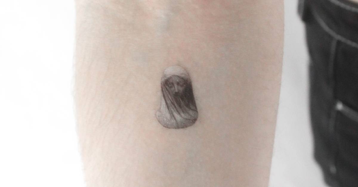 'The Veiled Virgin' temporary tattoo located on the