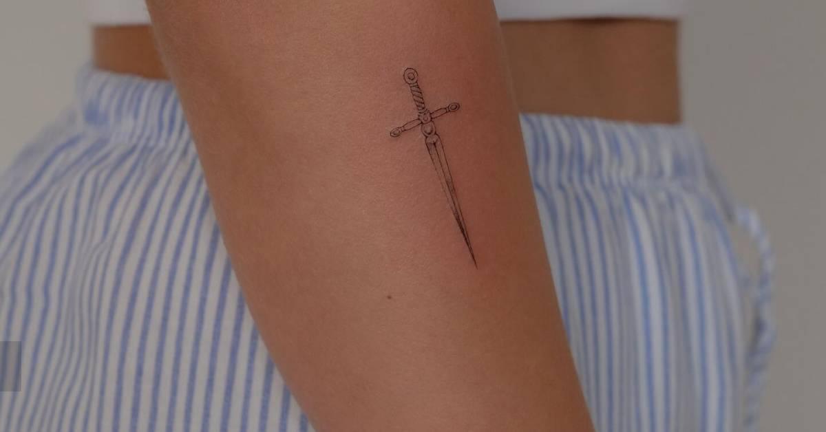 Dagger tattoo placed on the forearm, done in fine line