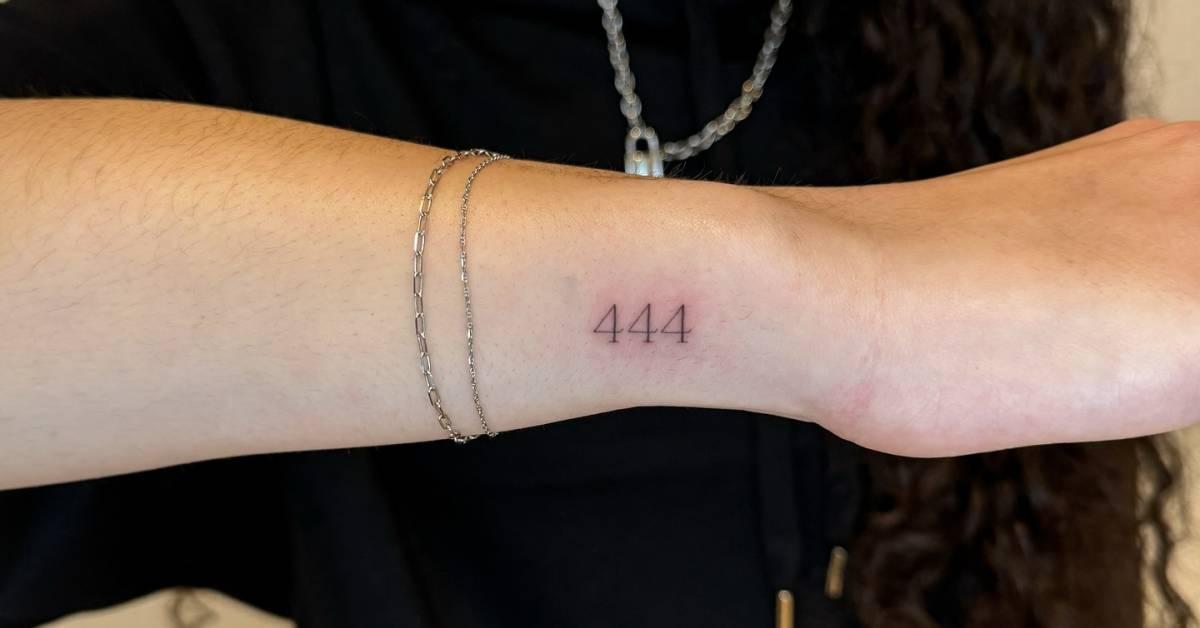 Angel number "444" tattoo located on the wrist.